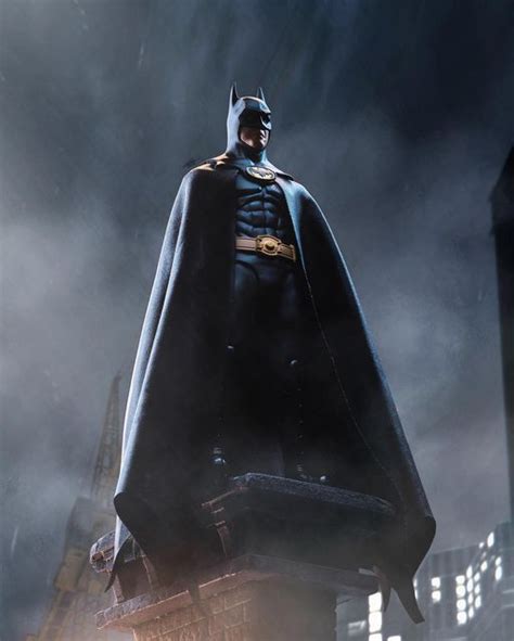A Batman Standing On Top Of A Building In The Rain