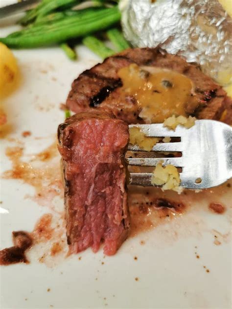 The Medium Rare Beef Steak And A Baked Potato In The Dinner Meal On The Way Play The Restaurant