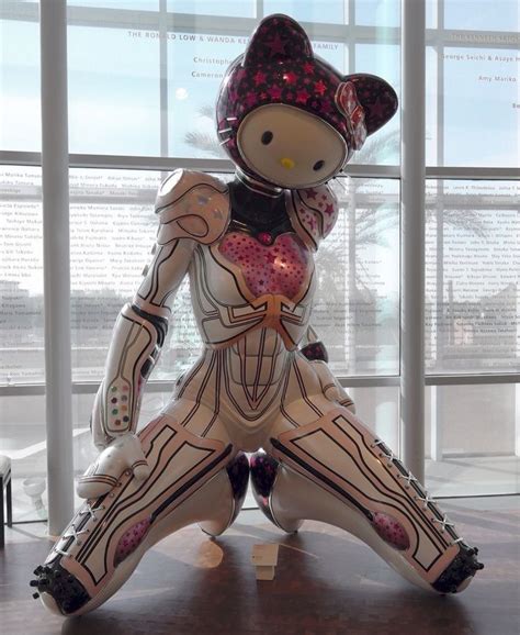 A Hello Kitty Statue Sitting On Top Of A Wooden Table In Front Of A Window