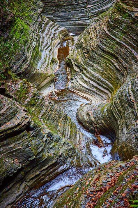 Small River Through Gorge In Detail Of Layered Rocks And Moss Stock