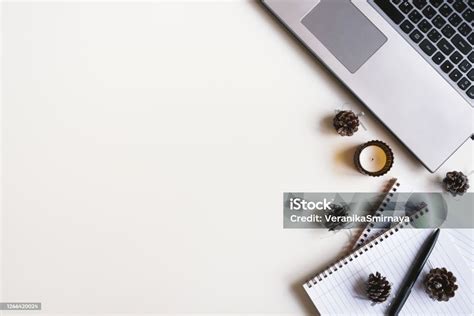 홈 오피스 데스크 플랫 레이 노트북 키보드 메모 패드 펜 촛불 및 장식 소나무 콘 가을과 겨울의 분위기 겨울에 대한 스톡 사진