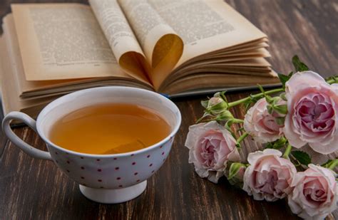 Vue Latérale Dune Tasse De Thé Avec Livre Ouvert Et Roses Roses Sur