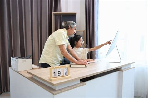 Young Asian Schoolgirl Is Doing Her Class Homework Assignment At Home With Advice From