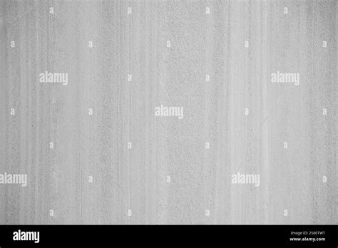 A Clean White Concrete Wall Showing Vertical Textures And Subtle