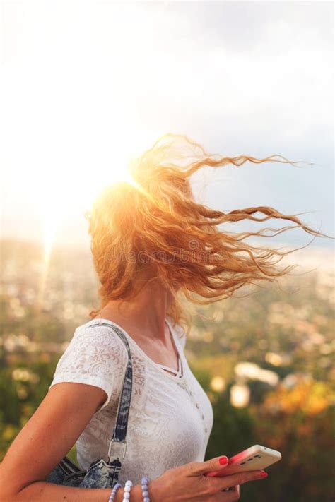 Redhead Urban Woman With Smartphone In Sunset Book Cover Stock Image