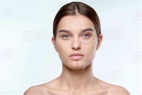 Portrait Of Young Woman With Correction Lines Isolated On White Stock