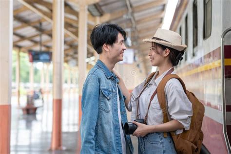 Happy Asian Couple Holding Suitcases And Camera Preparing To Wait For