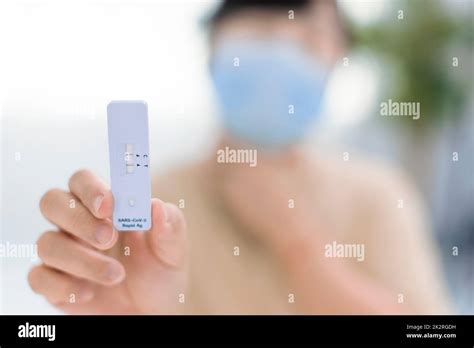 Woman Holding Rapid Antigen Test Kit With Positive Result During Swab