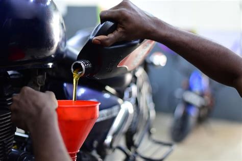 Premium Photo Man Servicing A Bike In A Garage