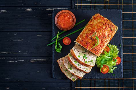맛 있는 수 제 지상 녹색 완두콩과 검은 테이블에 브로콜리 닭 고기를 구운 음식 미국 고기 덩어리입니다 상위 뷰 미트 로프