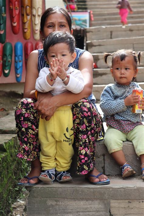 Nepali Mother Guide Two Of Her Daughter Who Wearing Traditional