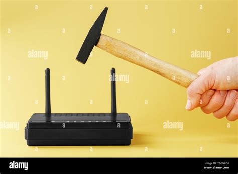 Hammer Over The Wi Fi Router For Destruction On A Yellow Background Annoying Internet With
