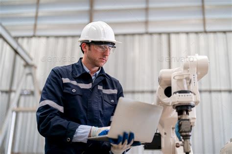 robotics engineer operating robot aided cnc machine in robotics