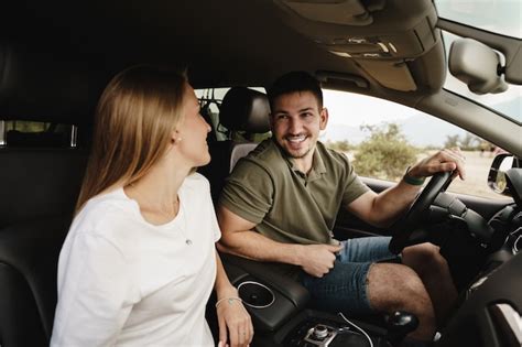 Premium Photo Beautiful Young Couple Sitting On Front Passenger Seats