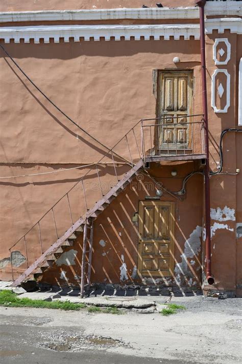 The Wall Of A 19th Century House With A Wooden Door Stucco An Iron