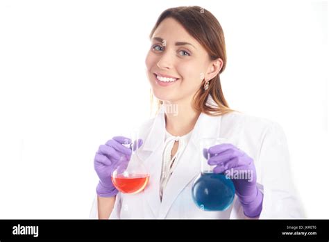 Young Smiling Woman In Scientific Cloth Holding Flasks With Colored