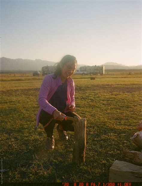 Woman Chopping Wood At Campsite By Stocksy Contributor Ryan Tuttle Stocksy