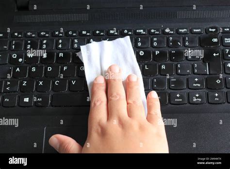 Clean Computer Keyboard With Antibacterial Wet Towel Virus Prevention