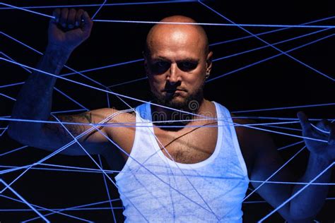 Serious Bald Man Tangled In Threads In Ultraviolet Stock Photo Image