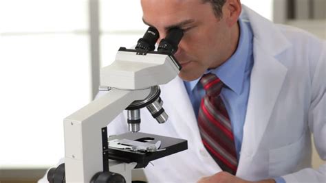 Close Up Doctor Looking Into The Microscope Stock Footage Video