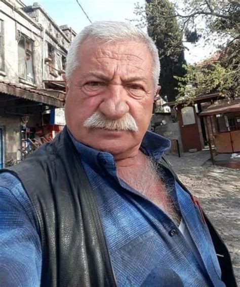 An Older Man With A Mustache And Leather Vest