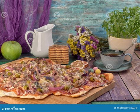 Pizza On Thin Dough With Slices Of Salami And Ham Olives And Tomatoes