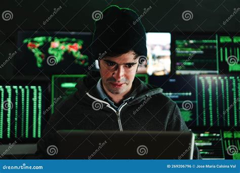 Concentrated Hacker Man Programmer Or Developer Typing Software Code On A Laptop Computer At