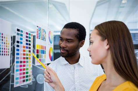 Free Photo Male And Female Graphic Designers Interacting Over Color Chart