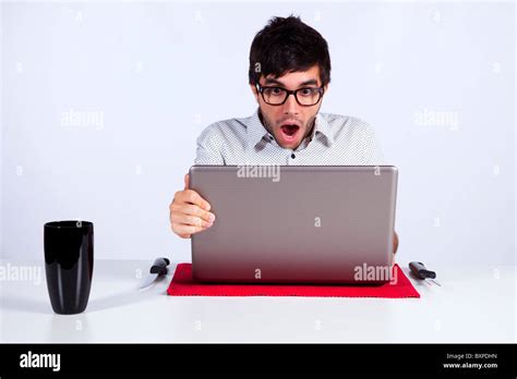 Young Man Shocked With Something He See On His Laptop Computer Stock