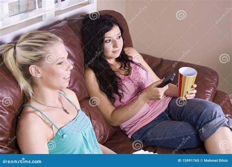 Two Girls Sitting On The Sofa Watching A Movie Stock Image Image Of