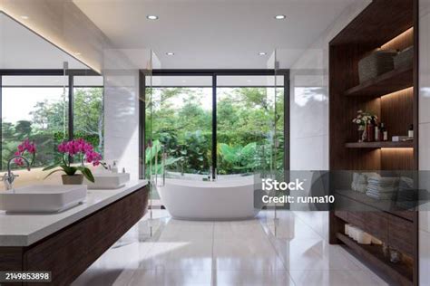 modern white bathroom with clear glass partition separating dry and wet