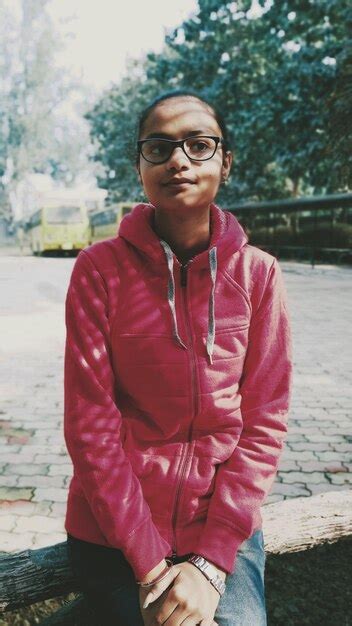 Premium Photo Young Woman Wearing Eyeglasses Looking Away While