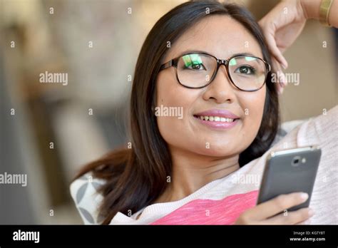Asian Girl Relaxing At Home Connected Wih Smartphone Stock Photo Alamy