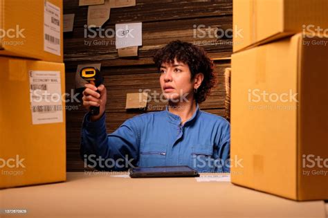 한 여성 근로자가 바코드를 스캔하여 소포 창고 공장에서 주문을 확인합니다 바코드 스캐너에 대한 스톡 사진 및 기타 이미지