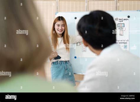 Creative Team Collaboration On Ux Ui Design Project In Modern Office Setting With Whiteboard And