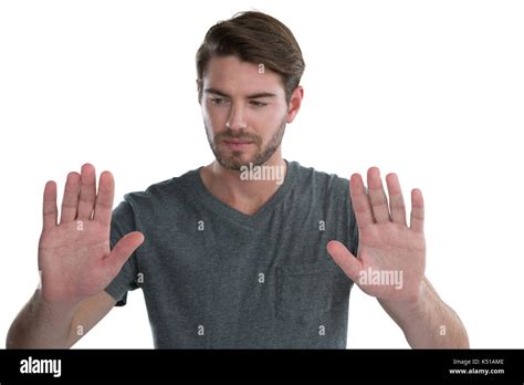 Man Pretending To Touch An Invisible Screen Against White Background