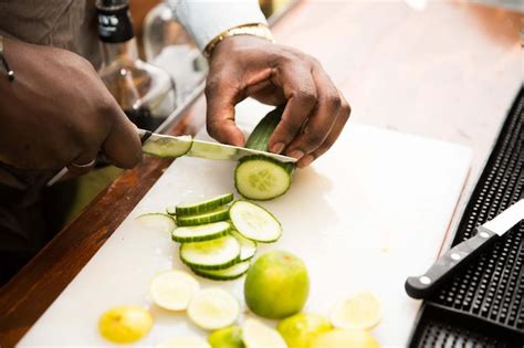 Premium Photo Man Cutting Cucumber In Kitchen