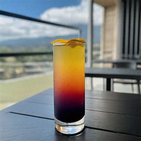 Solar Eclipse Exotic Cocktail With Spiced Rum Passion Fruit Blackberry And Lime