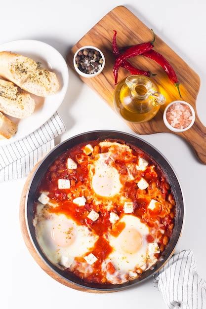 Premium Photo Shakshuka Made Of Poached Eggs In Tomato Pepper Sauce