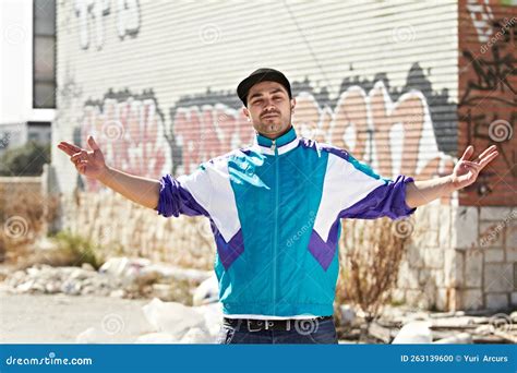 Cool And With Attitude A Gangster Standing In Front Of A Graffiti Wall