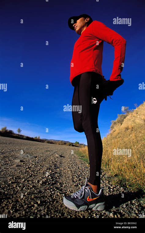 Attractive Female Runner Stretching In Tights With Nice Light Stock