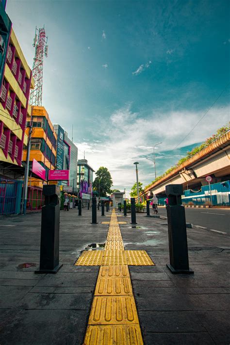 People Walking On Sidewalk Near Buildings During Daytime Photo Free