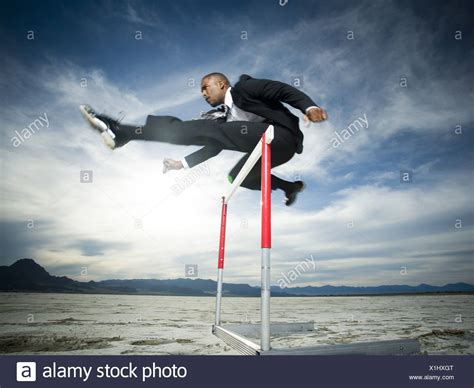 Businessman Jumping Over Hurdle Stock Photos Businessman Jumping Over Hurdle Stock Images Alamy