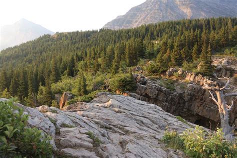 Swiftcurrent Falls Scenic Waterfall Backed By Mt Grinnell