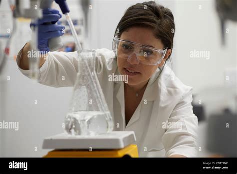 Attractive Female Scientist Testing Using Beaker And Peppet In