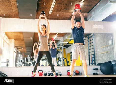 Happy Caucasian Couple Doing Strength Exercises With Kettlebell While