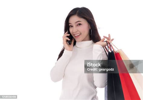 스마트폰으로 말하고 흰색 배경에 고립된 쇼핑백을 들고 있는 여성 가방에 대한 스톡 사진 및 기타 이미지 가방 무선 기술 사람들 Istock