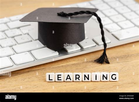 Learning Concept Graduation Cap On Computer Keyboard Stock Photo Alamy