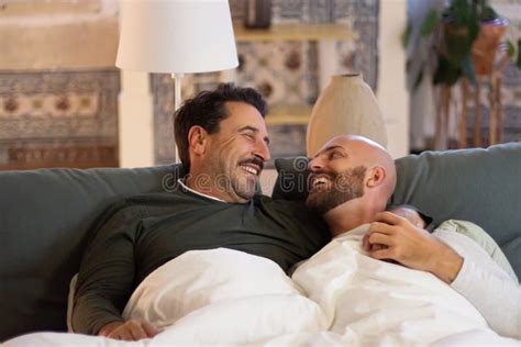 Happy Gays Laughing While Lying In Bed In Morning Stock Image Image