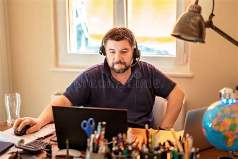 Man With Headphones And Microphone Having Conference Call Online